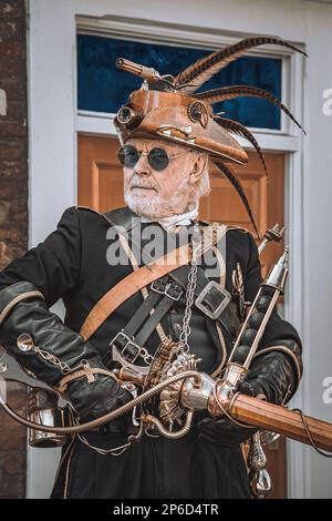 Portrait of a retro futuristic steampunk pirate holding a weapon ...