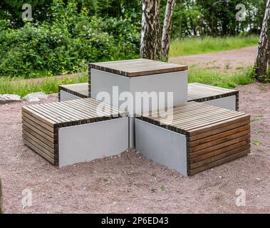 Bench formed as cubes with wood seating Stock Photo - Alamy