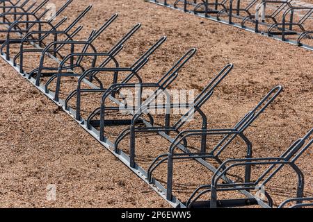 Row of bicycle racks on gravel ground Stock Photo - Alamy
