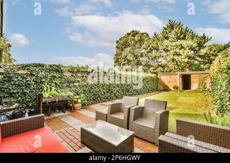 an outdoor patio area with wickers, chairs and table in the foreground ...