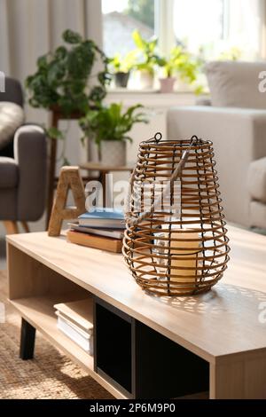 Stylish holder with books on table near white brick wall Stock Photo ...