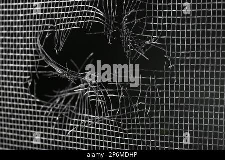 Torn window screen against black background, closeup Stock Photo - Alamy