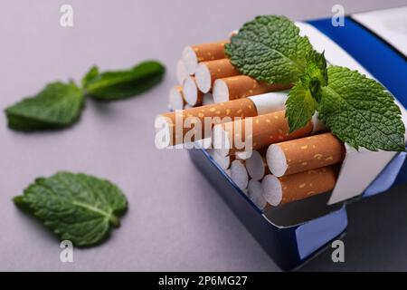 Many cigarettes on grey background Stock Photo - Alamy