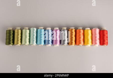 Colorful sewing threads on grey background Stock Photo - Alamy