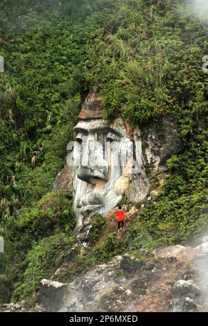 A visitor is spotted near a giant face formation illustrating the ...