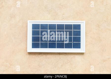 Portable solar panel on beige wooden background Stock Photo - Alamy