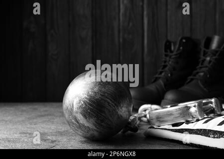 Prisoner ball with chain and jail clothes on grey table, flat lay ...