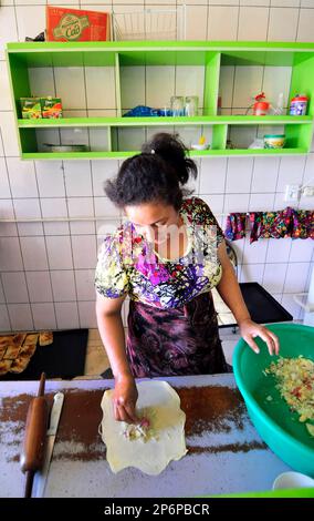 An Uzbek woman rolling dough in preparation of Samsa ( flaky baked meat ...