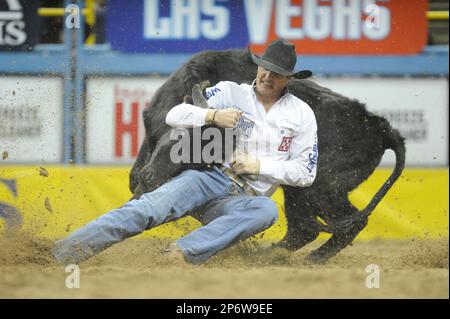 Trevor Knowles wrestles a steer during rodeo action at the Calgary ...