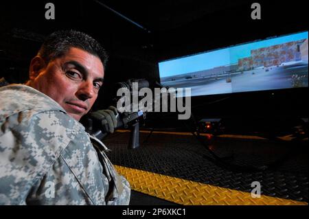 A weapons officers fires a machine gun during a live fire drill aboard ...