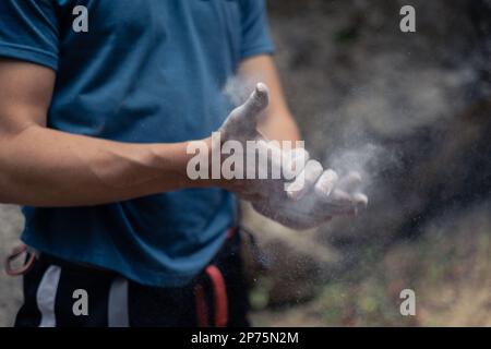 Magnesium dust flying into the air as climber removes excess by ...