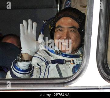 Japanese astronaut Satoshi Furukawa waves his hand before abording ...