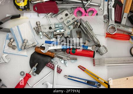 Messy tool desk top view scattered and unorganized work tools no people ...