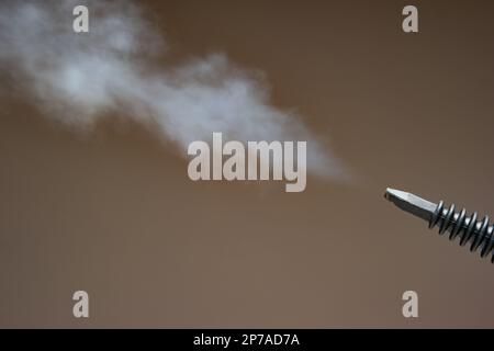 Steam pressure cleaner plastic nozzle spraying water vapor cloud. Close ...