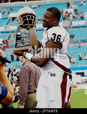 Mississippi State Quaterback (36) Chris Relf holds up his MVP trophy ...