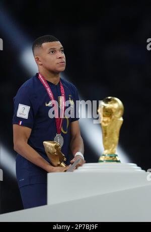 France's Kylian Mbappe walks past the FIFA World Cup trophy after being ...