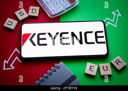 In this photo illustration a Keyence logo seen displayed on a ...