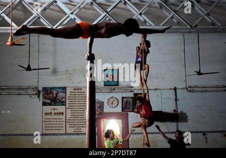 Indian gymnasts perform Mallakhamb at a gymnasium in Mumbai, India ...