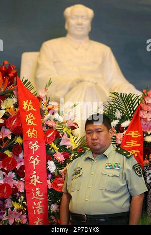 Mao Xinyu, grandson of late Chinese leader Mao Zedong, lays a wreath to mark Mao Zedong's 117th ...