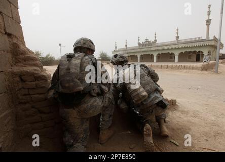 U.S. soldiers take cover behind a humvee during Combat Support Training ...