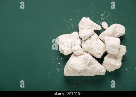 natural pieces of chalk mineral stones is on green chalkboard ...