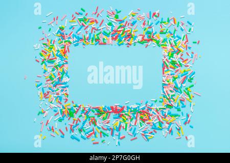 greeting wreath of colorful sprinkles blue background, festive ...