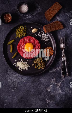 Fresh raw minced beef steak burgers with spices Stock Photo - Alamy