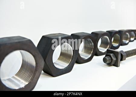 Row of large metal nuts Stock Photo - Alamy