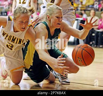 Wyoming point guard Randi Richardson, right, puts her hand up on ...