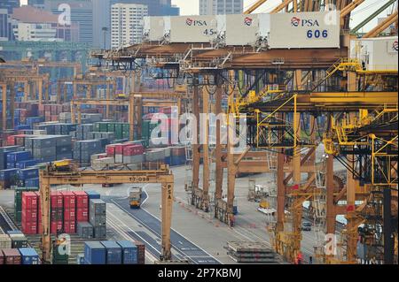 The Keppel and Brani container ports, with cranes loading and unloading ...