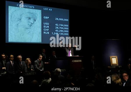 Christie's auctioneer James Bruce-Gardyne takes bids for the Raphael ...