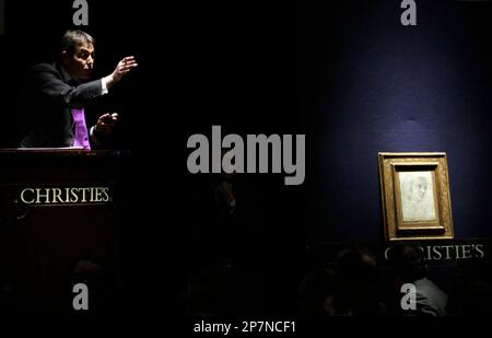 Christie's auctioneer James Bruce-Gardyne takes bids for the Raphael ...