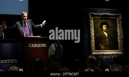 Christie's auctioneer James Bruce-Gardyne takes bids for the Raphael ...
