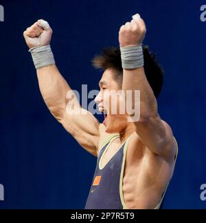 China's Lu Xiaojun reacts in the clear and jerk of the men's group A 77 ...