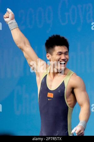 China's Lu Xiaojun reacts in the clear and jerk of the men's group A 77 ...