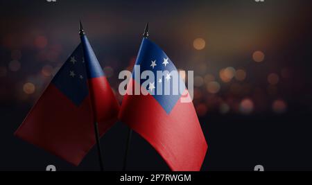 Small flags of the Samoa on an abstract blurry background Stock Photo ...