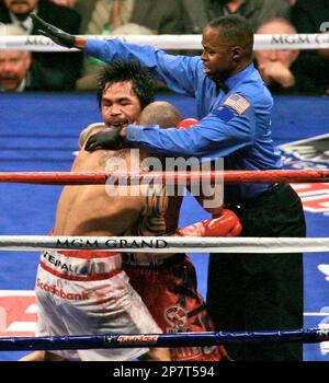 Referee Kenny Bayless, right, holds up the hand of Manny Pacquiao, of ...