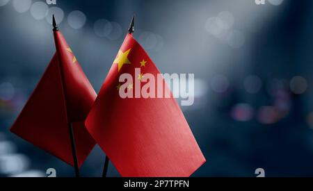 Small flags of the China on an abstract blurry background Stock Photo ...