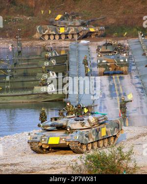 South Korean army tanks and armored vehicles cross a river during a ...