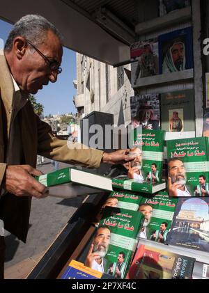 Copies of the book "Al Ra'ees Al Shaheed" (The Martyred President) by ...