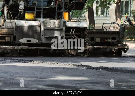 Modern asphalt finisher on city street. Road repair service Stock Photo ...