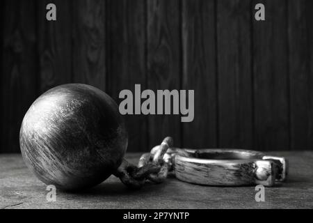 Prisoner ball with chain on grey table, top view. Space for text Stock ...
