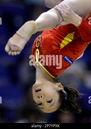China's Deng Linlin performs on the beam during women's qualifying for ...