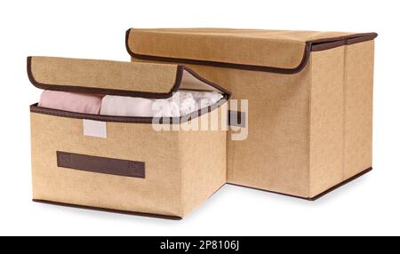 Textile storage cases with folded clothes on white background Stock ...