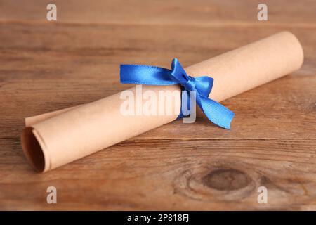 Rolled student's diploma with blue ribbon on white background Stock ...
