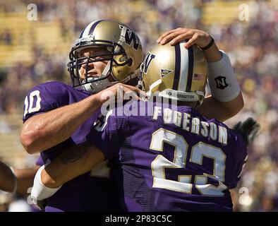 Washington running back Johri Fogerson, right, gets a hug from guard ...
