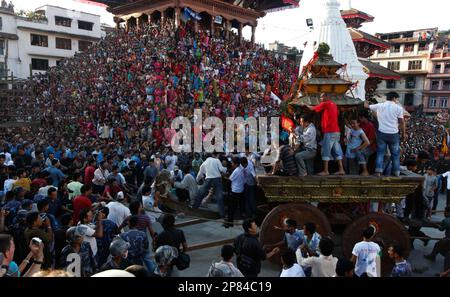Devotees pull the chariot of the Living Goddess Kumari during the ...