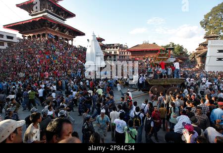 Devotees pull the chariot of the Living Goddess Kumari during the ...
