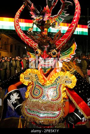A man dressed as a devil, dances during the celebrations of the ...