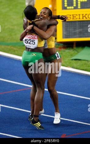 Jamaica's Brigitte Foster-Hylton, right, crosses the finish line to win ...